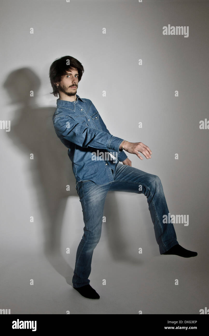 Young man balancing on one leg Stock Photo - Alamy