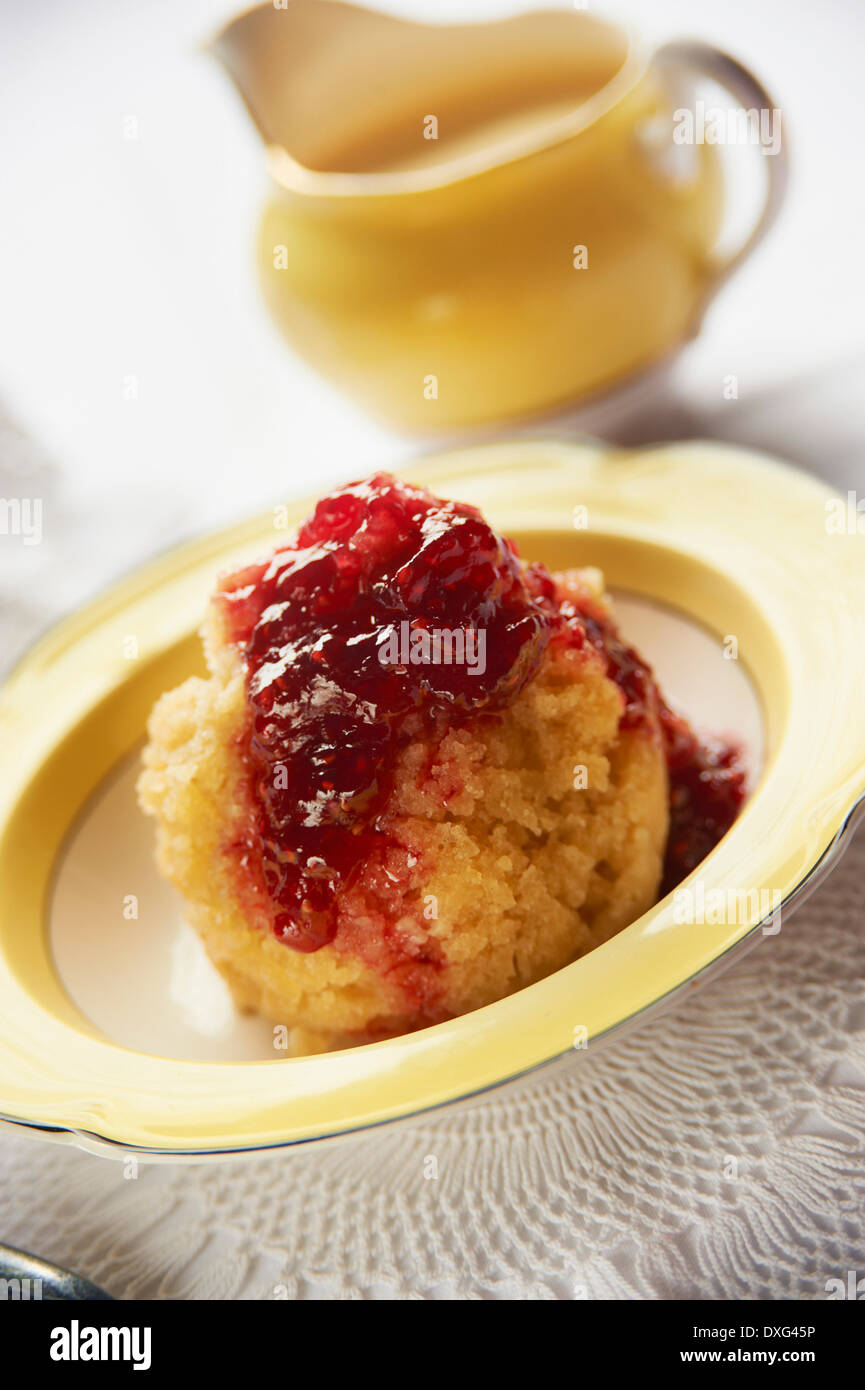 Bowl Of Steamed Jam Pudding With Jug Of Custard Stock Photo - Alamy