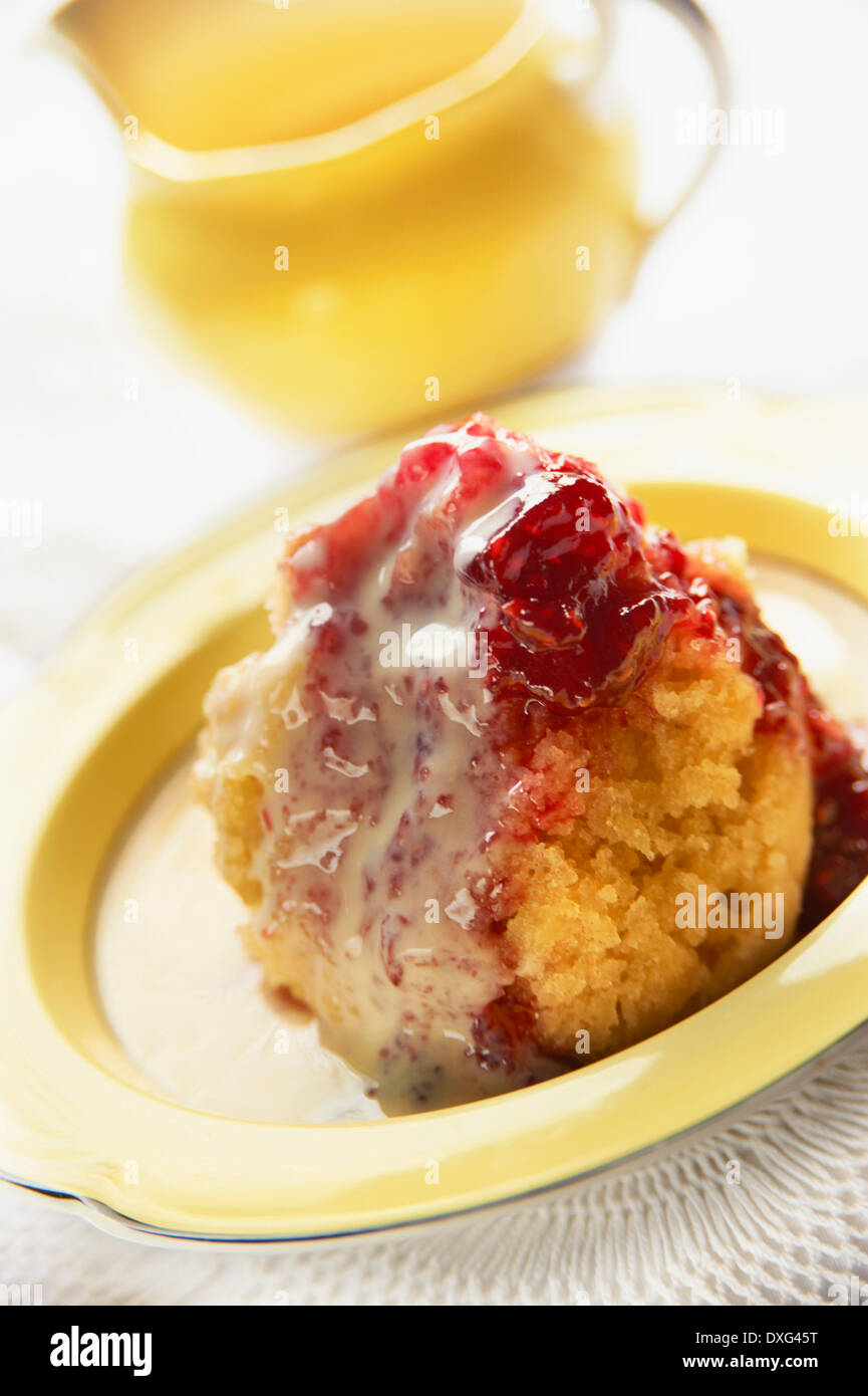 Bowl Of Steamed Jam Pudding With Jug Of Custard Stock Photo - Alamy