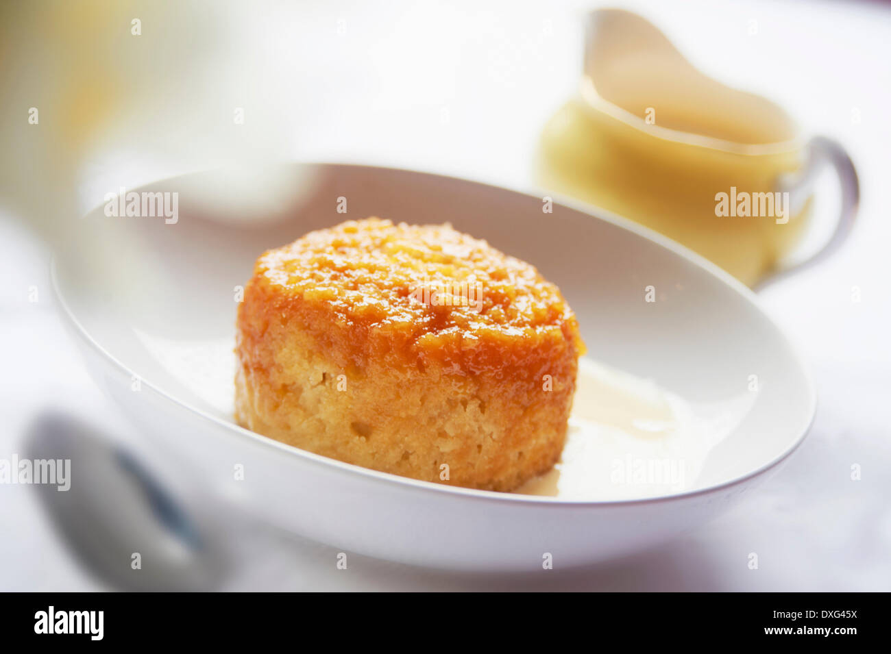 Bowl Of Steamed Syrup Pudding With Jug Of Custard Stock Photo - Alamy