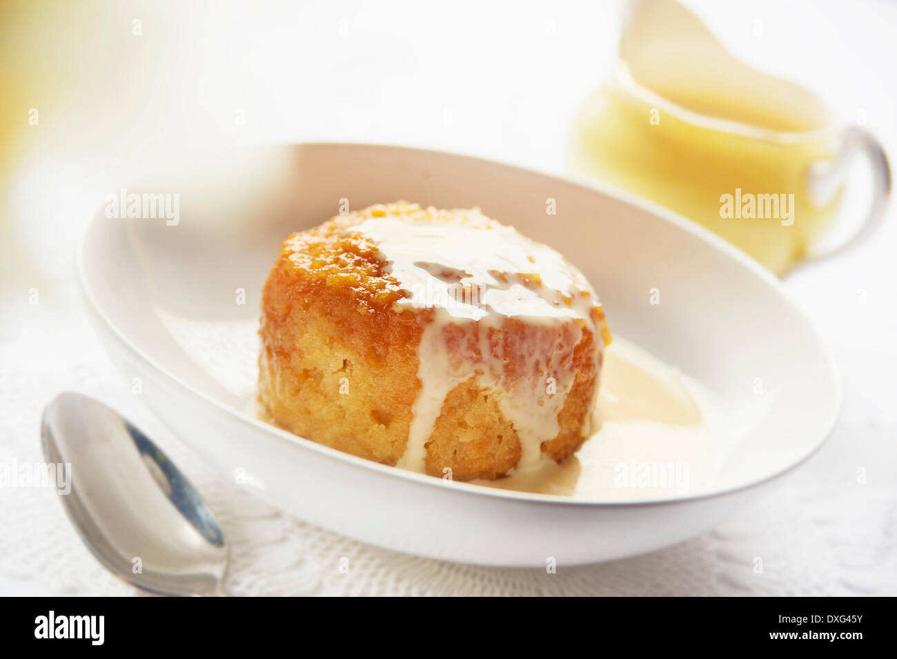 Bowl Of Steamed Syrup Pudding With Jug Of Custard Stock Photo - Alamy