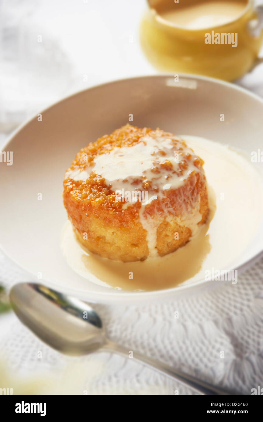 Bowl Of Steamed Syrup Pudding With Jug Of Custard Stock Photo - Alamy