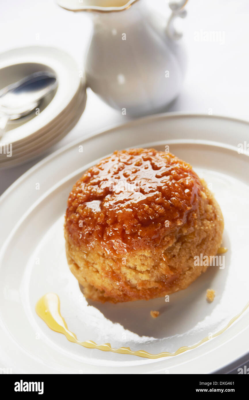 Bowl Of Steamed Syrup Pudding With Jug Of Custard Stock Photo - Alamy