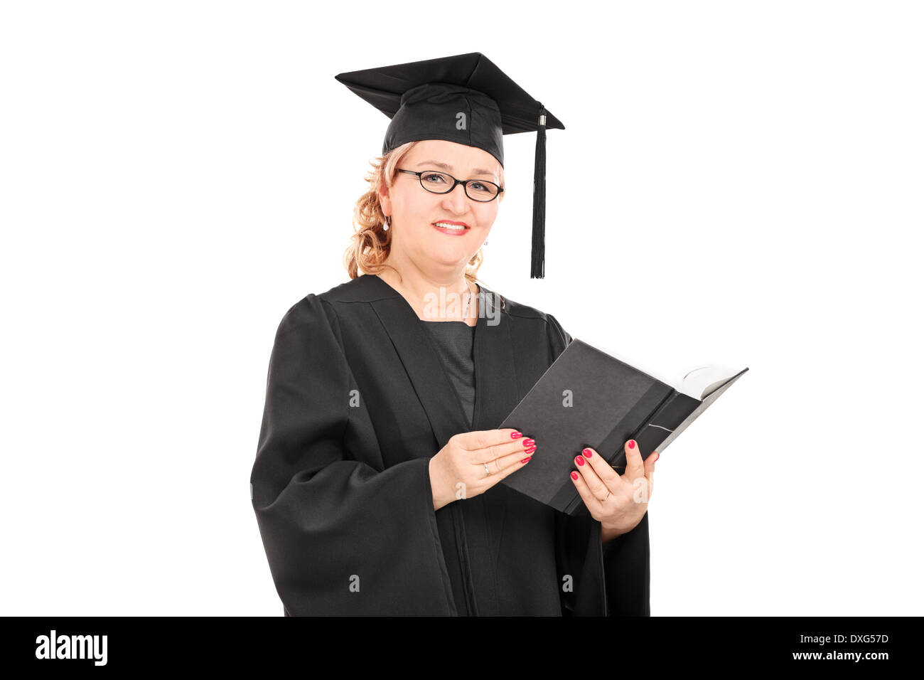 Woman in graduation gown reading a book Stock Photo - Alamy