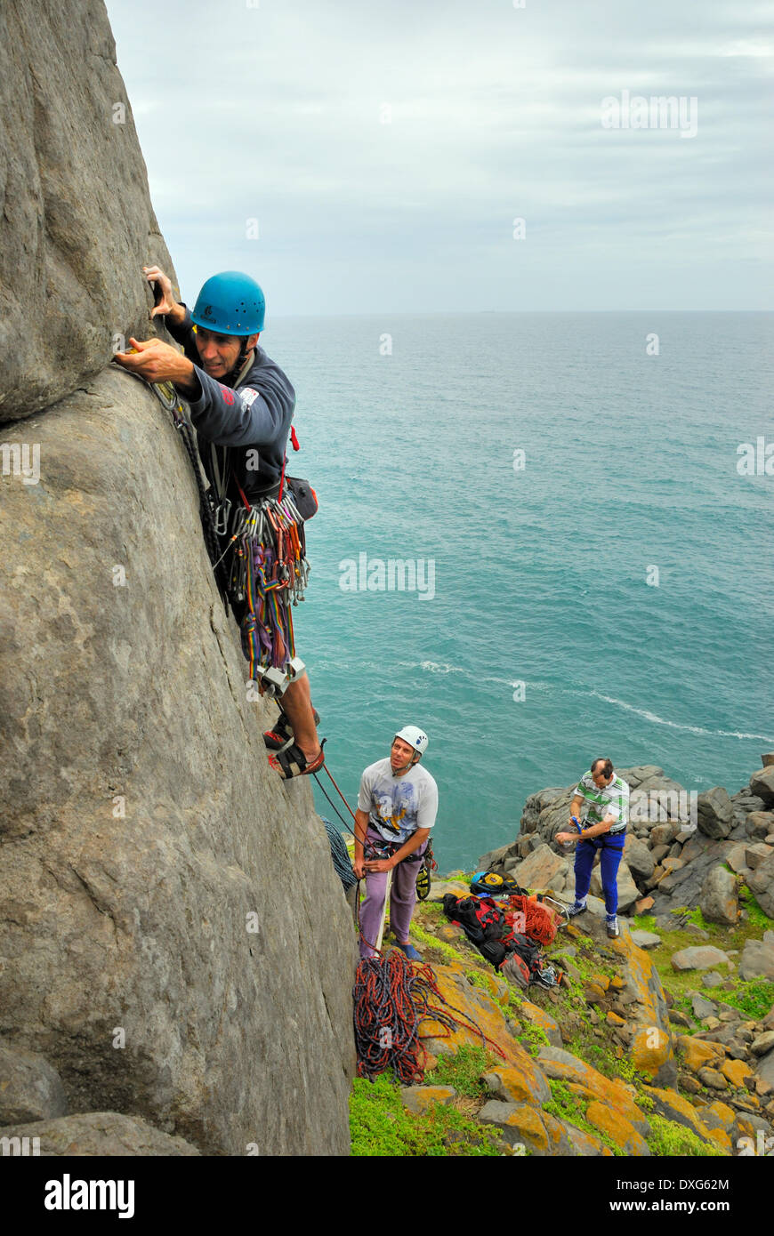 Rock climber on sea cliffs at Morgan Bay, Eastern Cape, South Africa ...