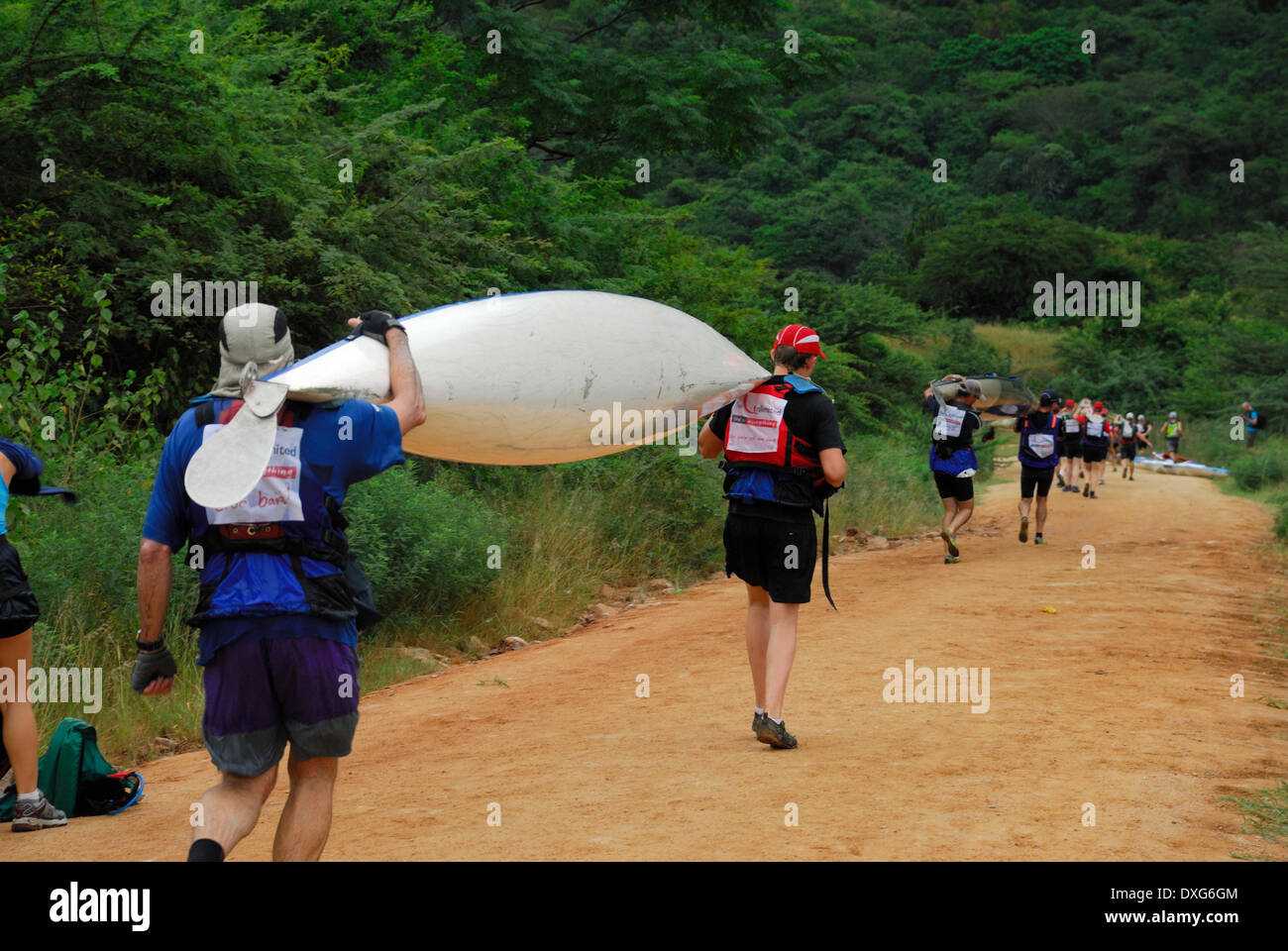 Paddlers portaging past Inanda Dam wall on the Dusi Canoe Marathon ...