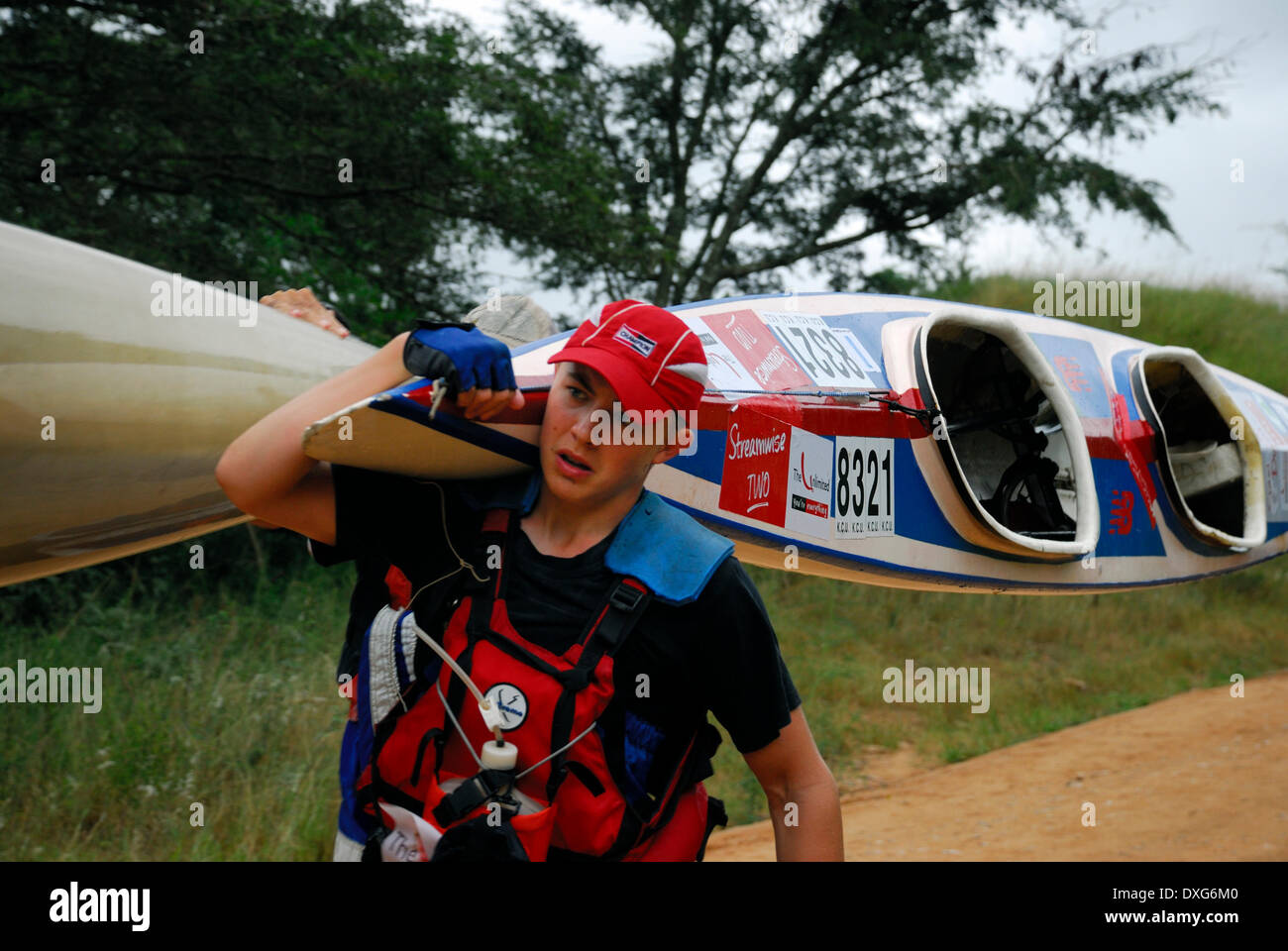 Paddlers portaging past Inanda Dam wall on the Dusi Canoe Marathon ...