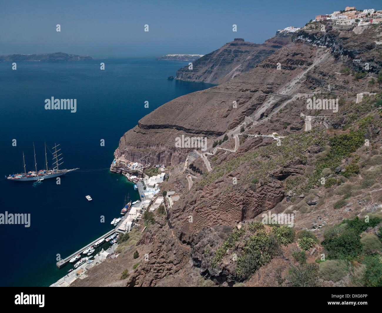 Cliffs and volcanic caldera below the town of Oia on the island of ...
