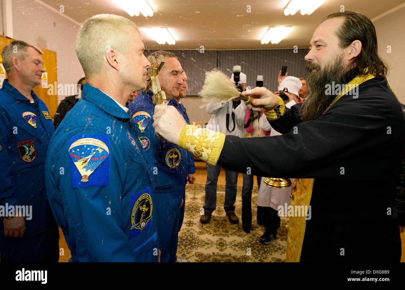 A Russian Orthodox priest blesses Expedition 39 astronaut Steve Swanson ...