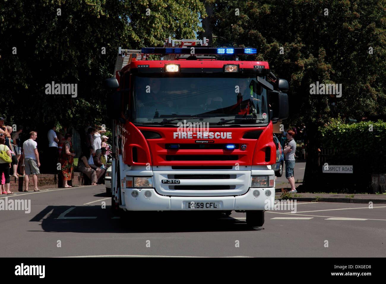 Fire engine, with lights flashing, taking part in a carnival day in ...