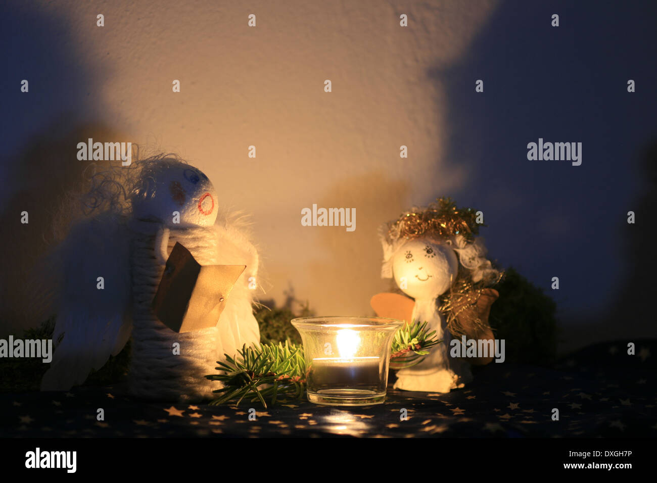 two Christmas angles, candle, Christmas ceiling, pine branches, moss ...