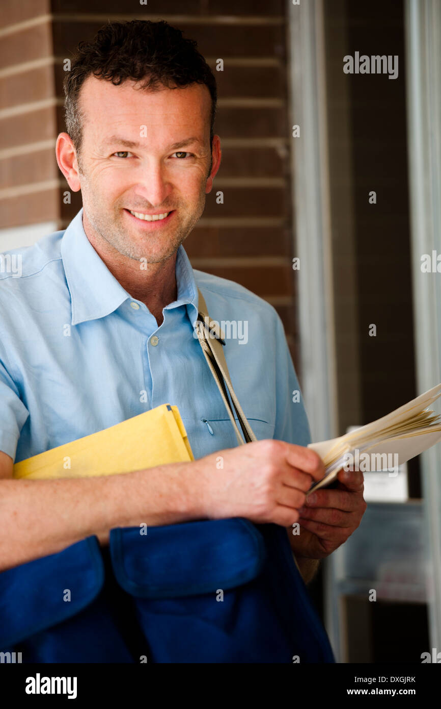 Mailman delivering mail Stock Photo - Alamy