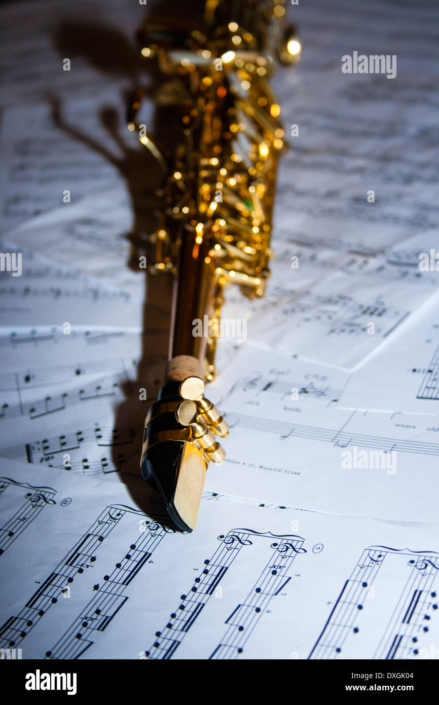 A soprano saxophone lying on sheet music Stock Photo - Alamy