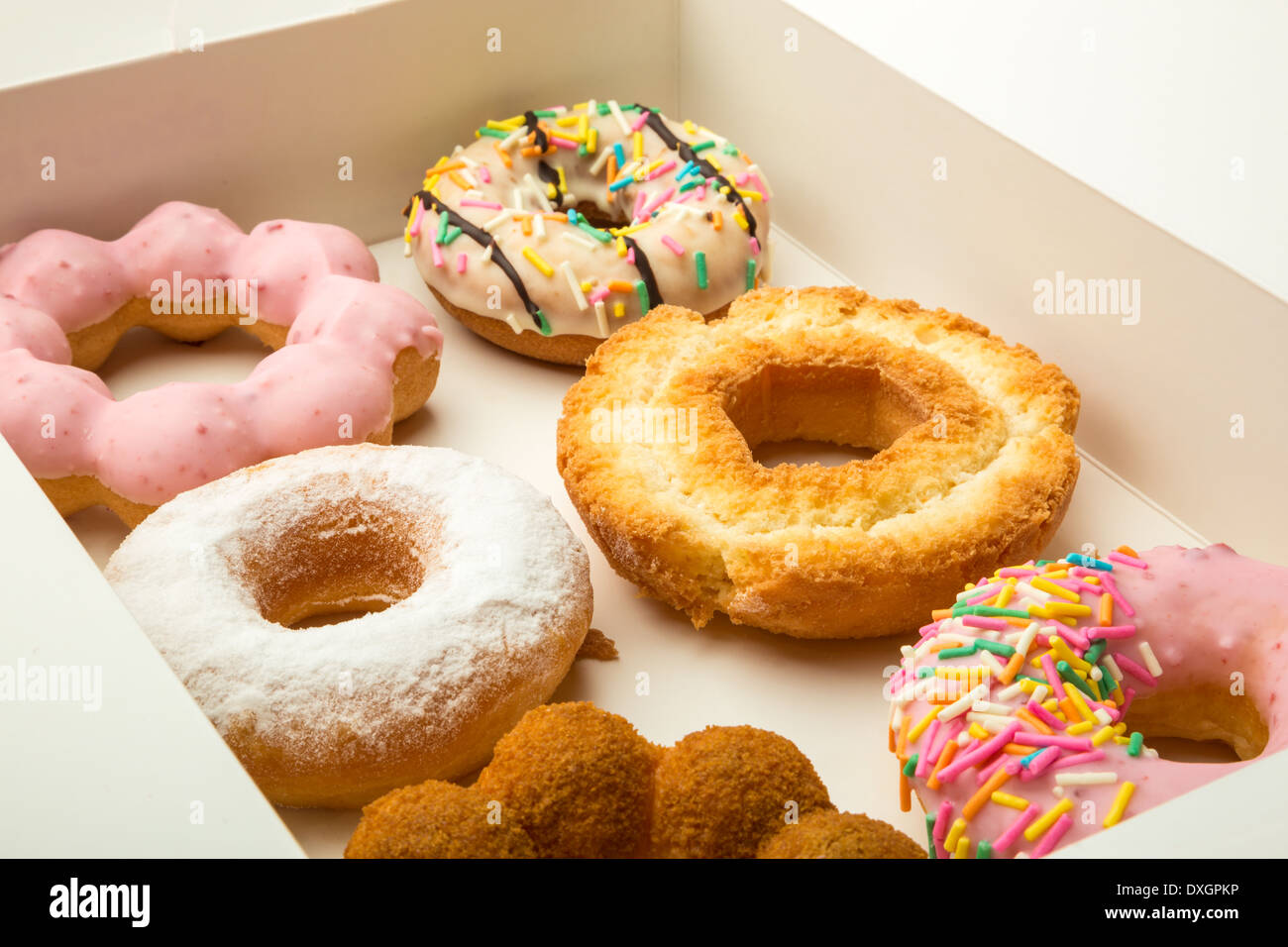 Six colorful assorted donuts in a box Stock Photo - Alamy