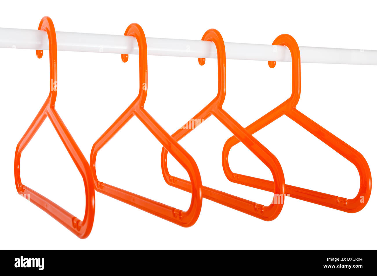 Orange plastic hangers hanging on a rod isolated on white background ...