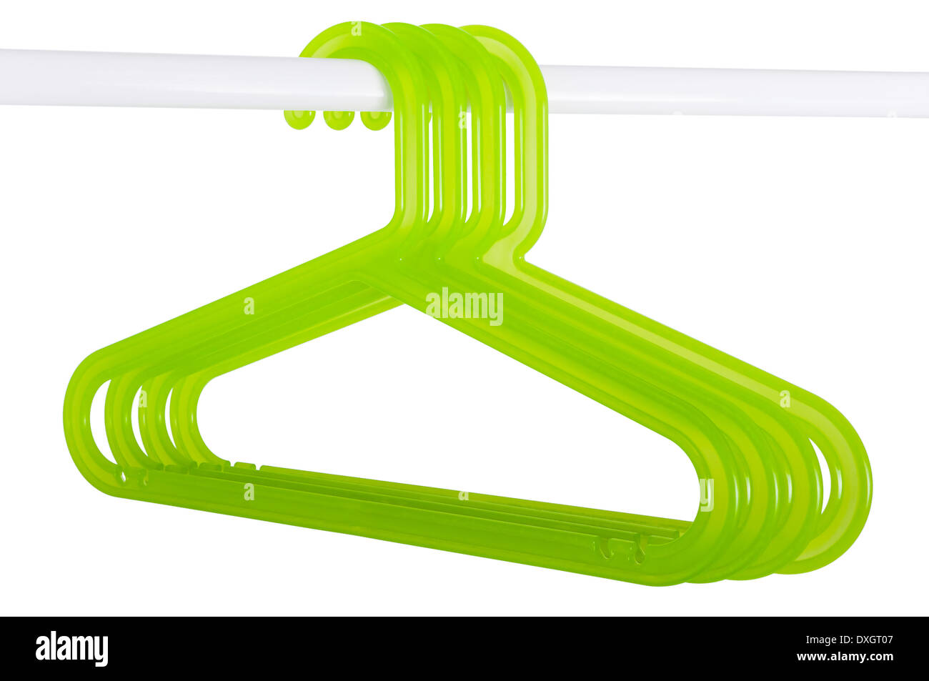 Green plastic hangers hanging on a rod isolated on white background ...