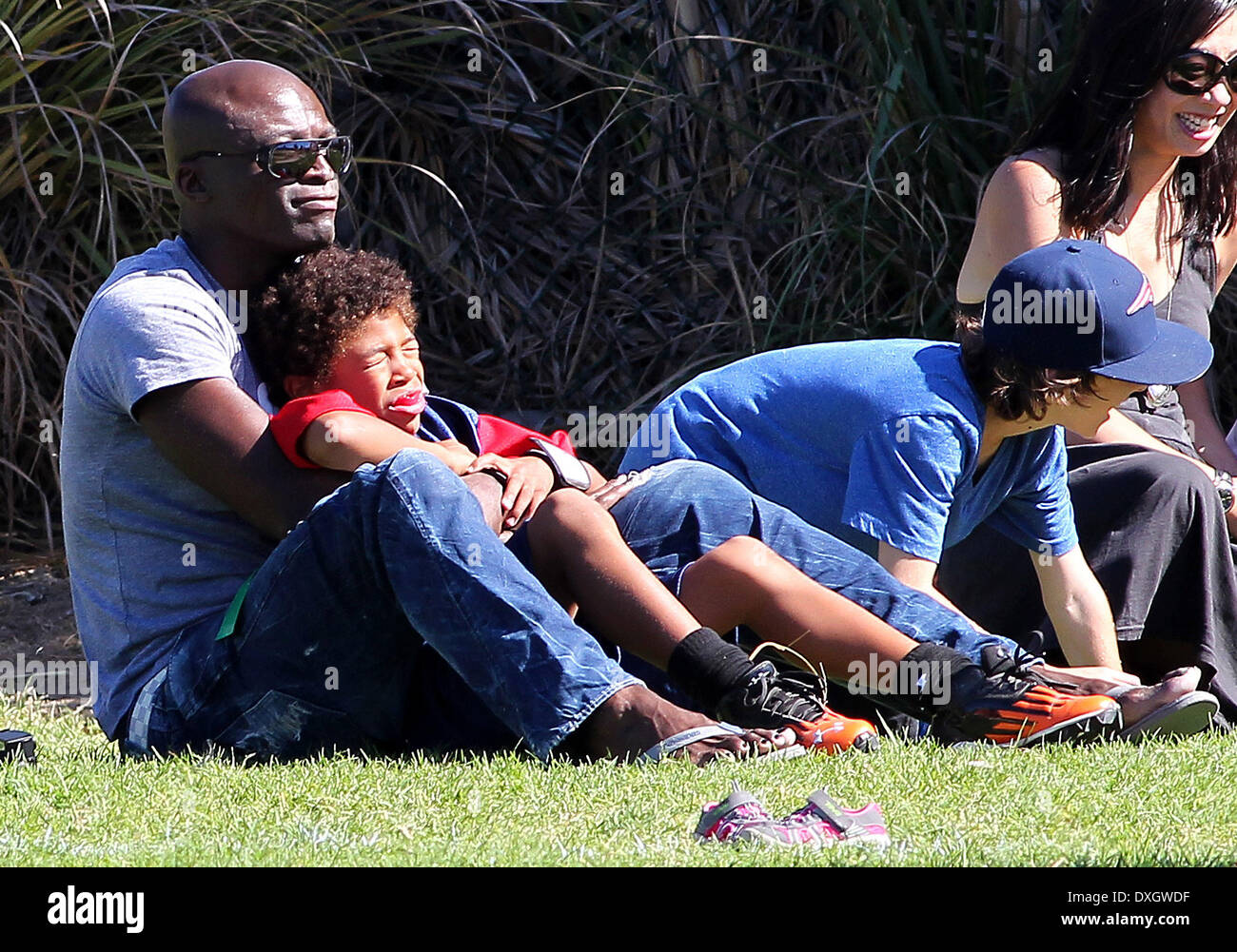 Henry Samuel and Seal Seal watching his son's soccer game with his ...