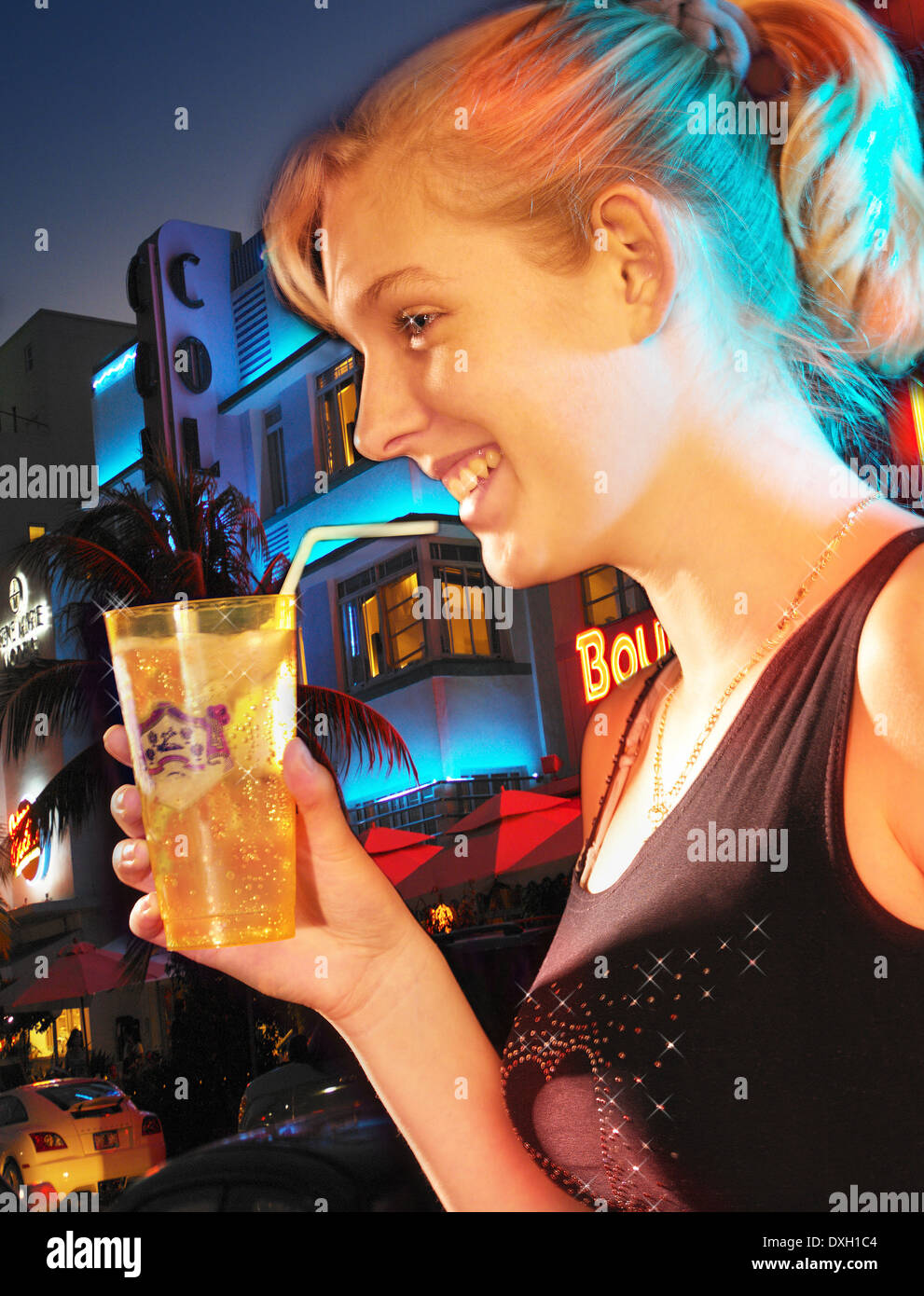 Young woman enjoying the nightlife on Ocean Drive in Miami Beach ...