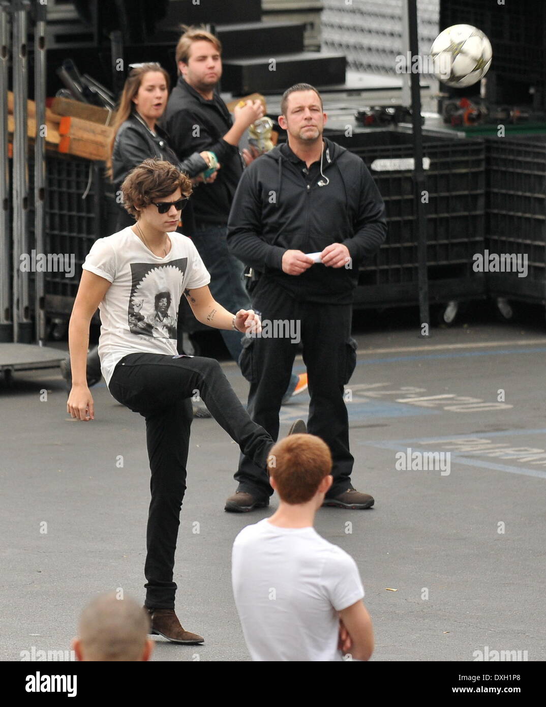 Harry Styles One Direction band members playing soccer in the parking ...