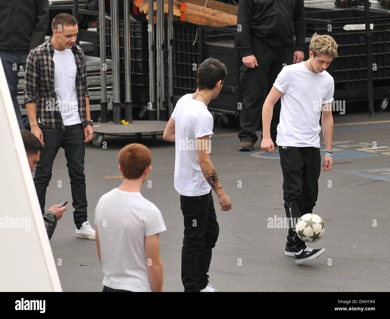 One Direction band members playing soccer in the parking lot of the X ...