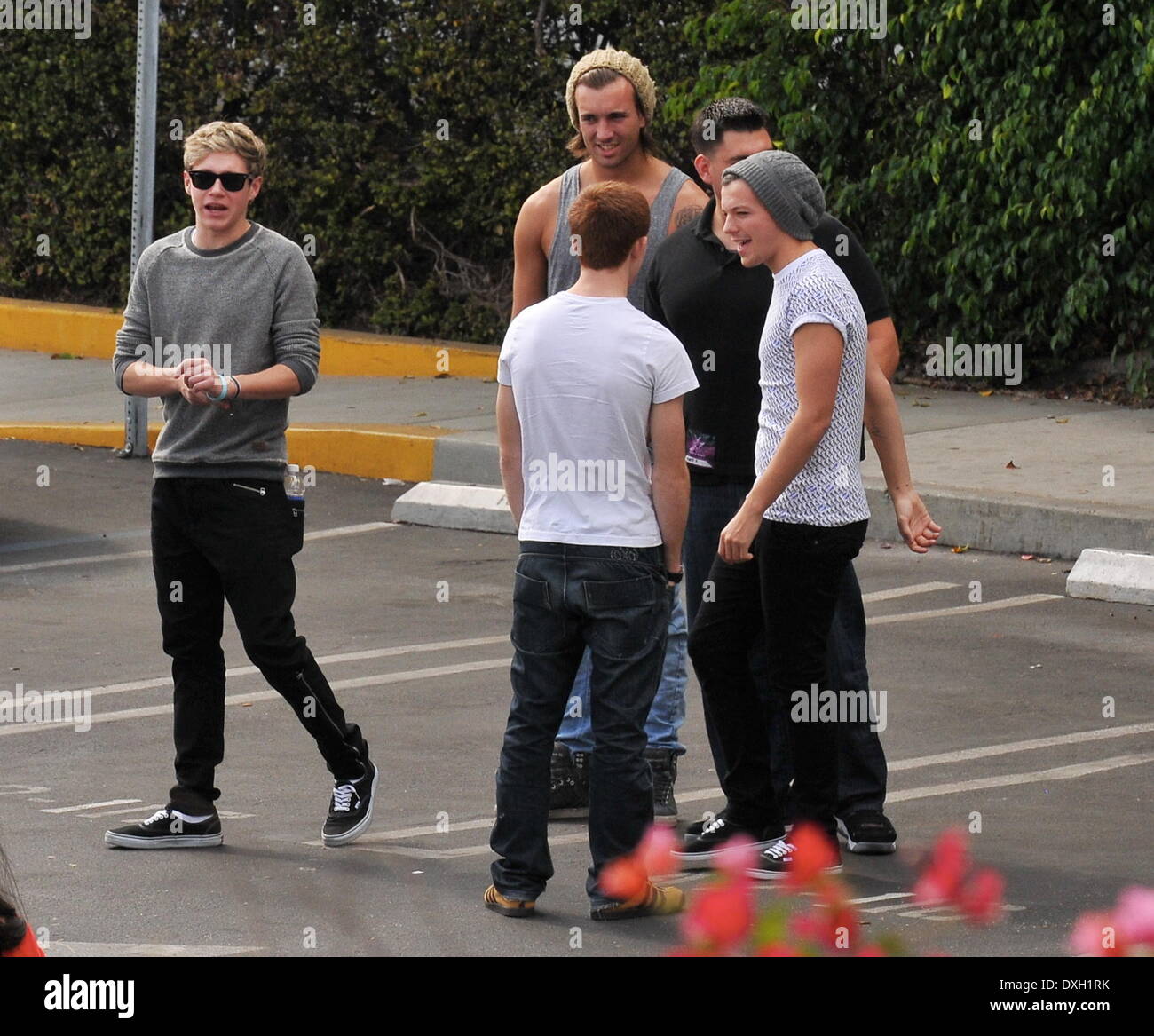 One Direction band members playing soccer in the parking lot of the X ...