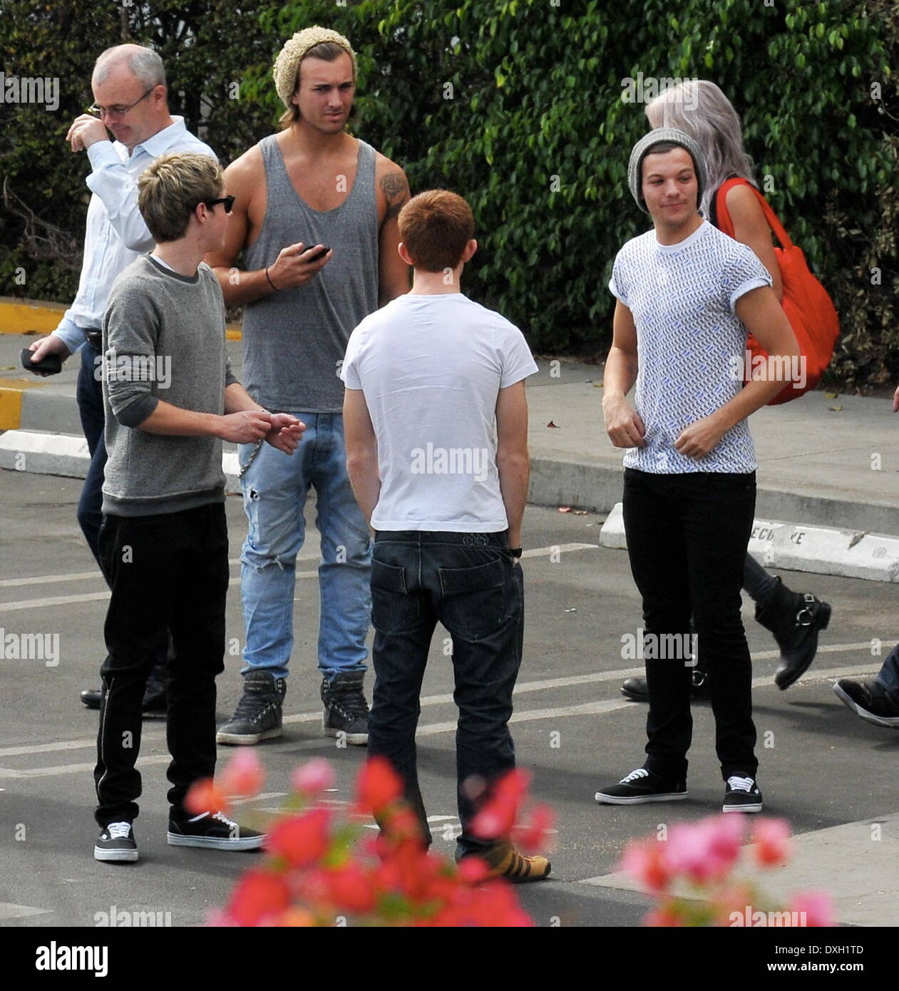 One Direction band members playing soccer in the parking lot of the X ...