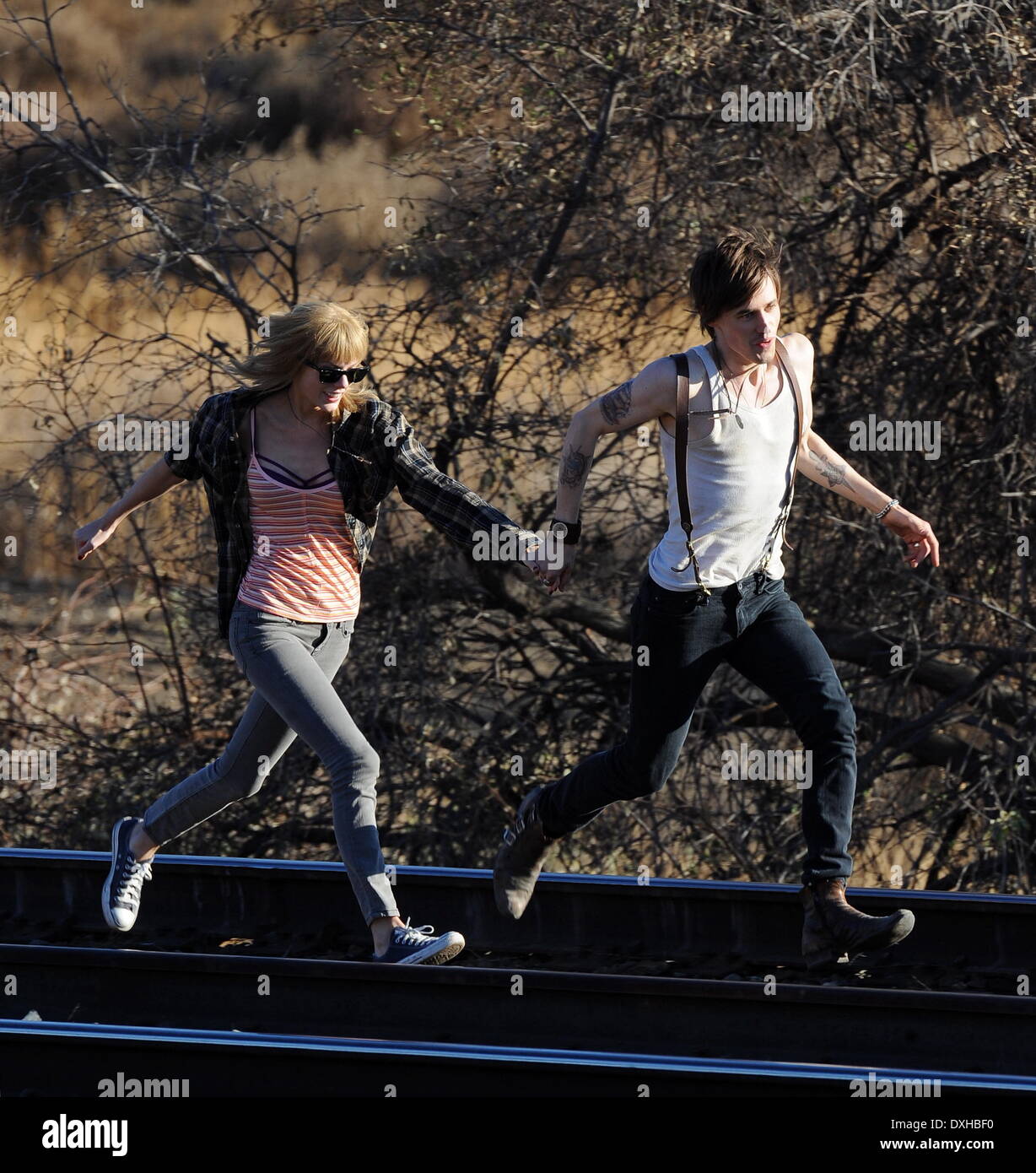 Singer Taylor Swift gets a piggy back ride by co star Reeve Carney on ...