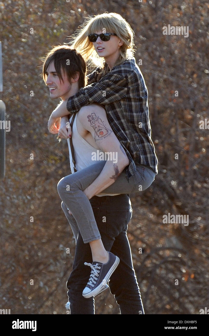 Singer Taylor Swift gets a piggy back ride by co star Reeve Carney on ...
