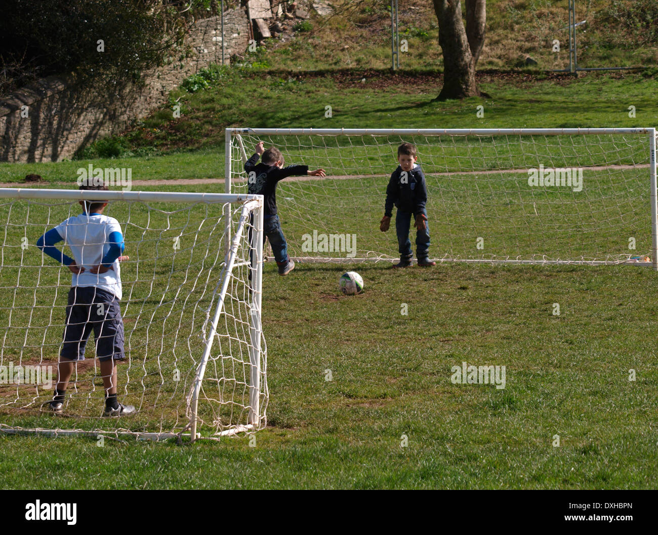 Young boys playing football in the park, Kingsbridge, Devon, UK Stock ...