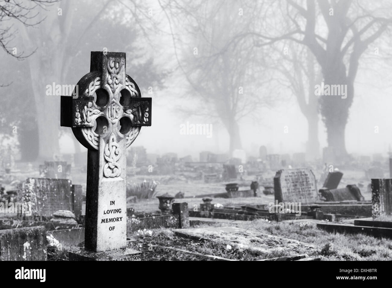 Cross Gravestone in the fog at Banbury Cemetery. Oxfordshire, England ...