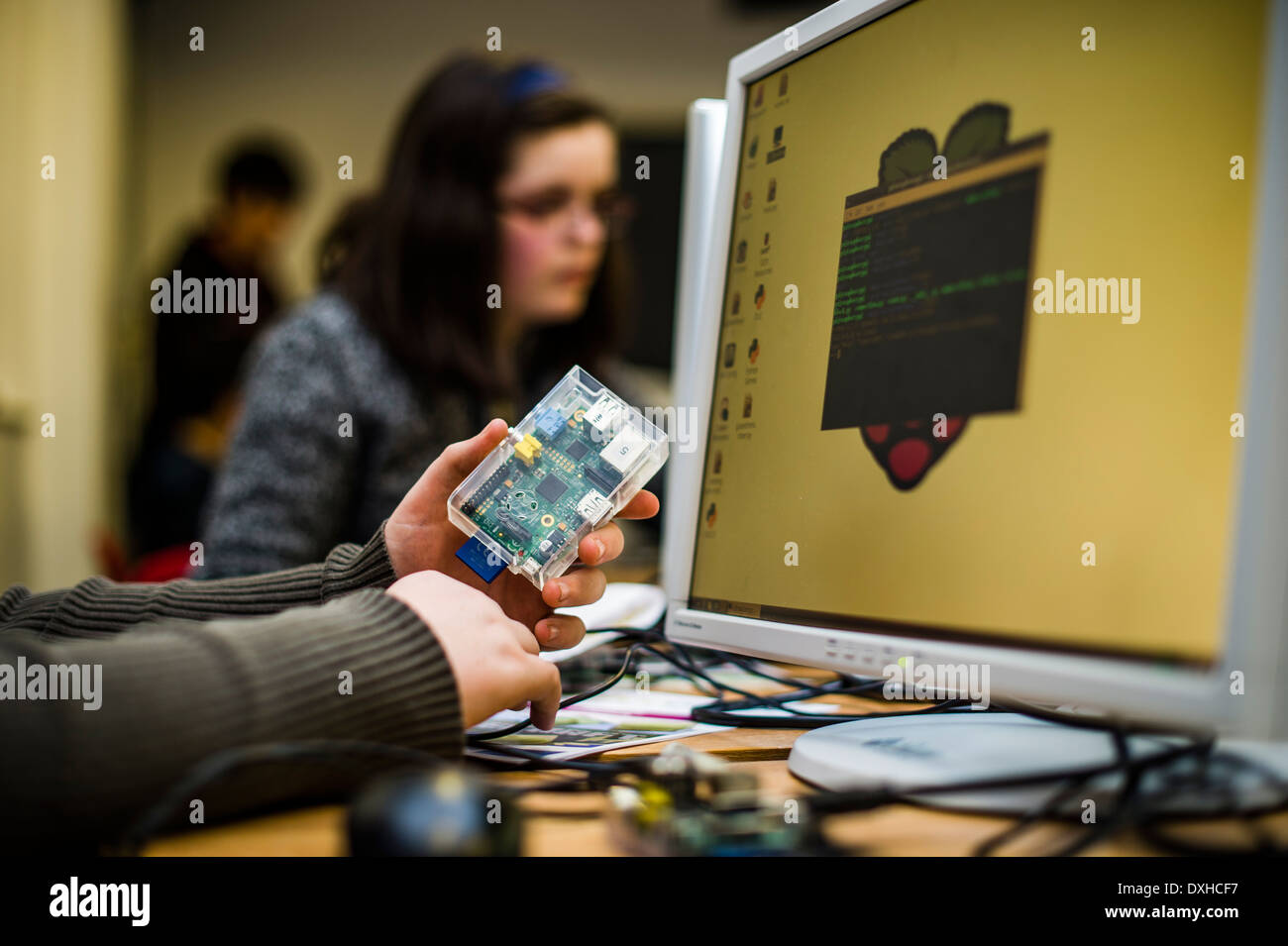 Teenagers at a computer workshop class writing code and learning to ...