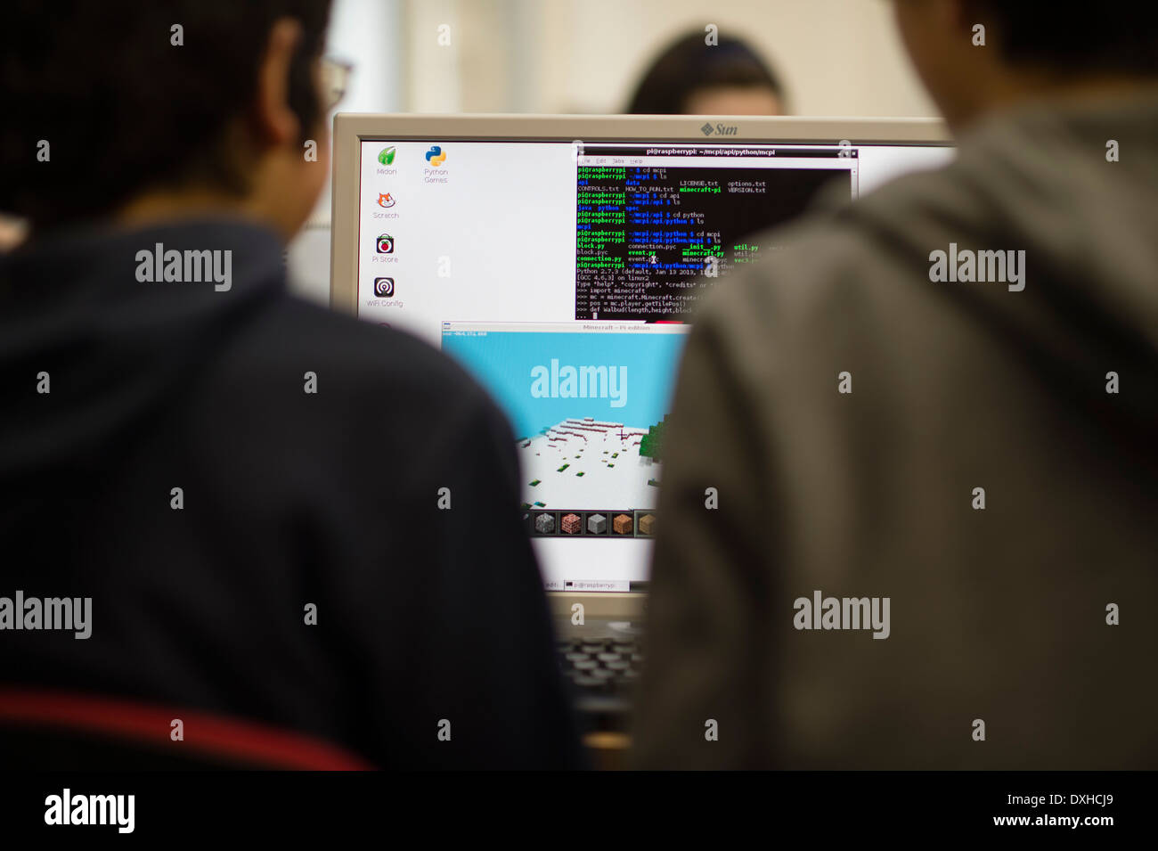Teenagers at a computer workshop class writing code and learning to ...