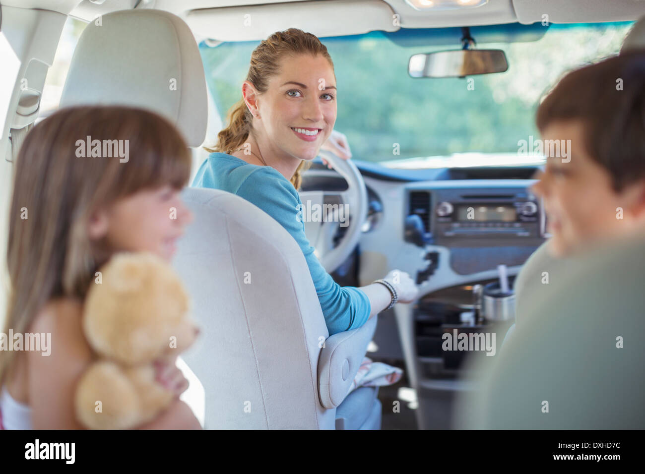 Portrait of smiling mother with family in car Stock Photo - Alamy