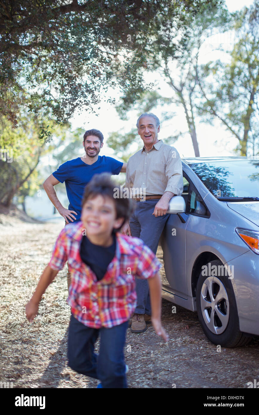 Happy multi-generation men outside car Stock Photo - Alamy