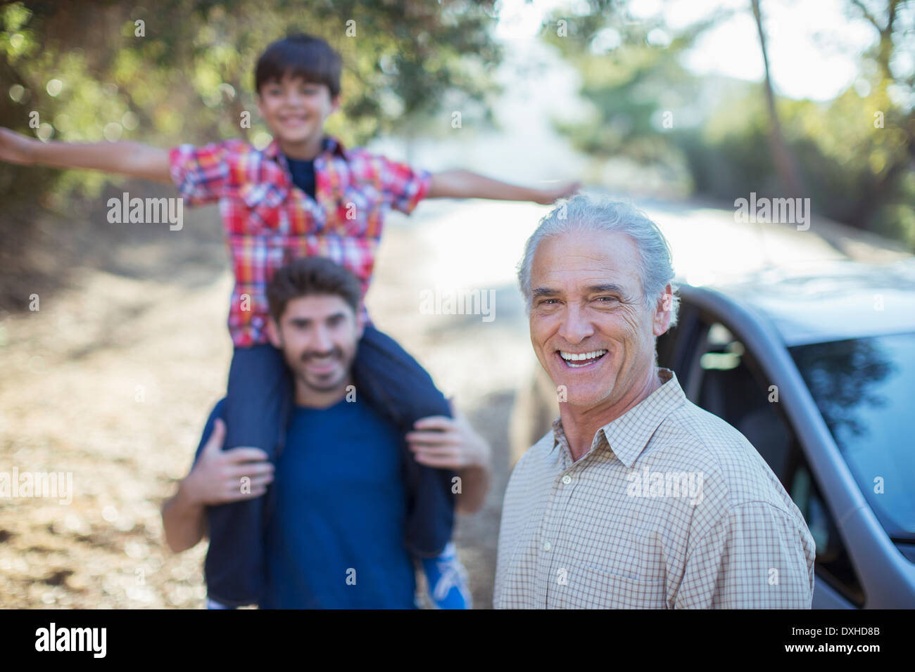 Portrait of happy multi-generation men outside car Stock Photo - Alamy