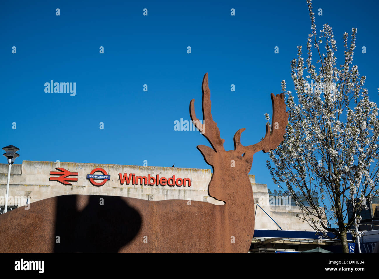 Wimbledon train station with deer sculpture and tree in blossom, London ...
