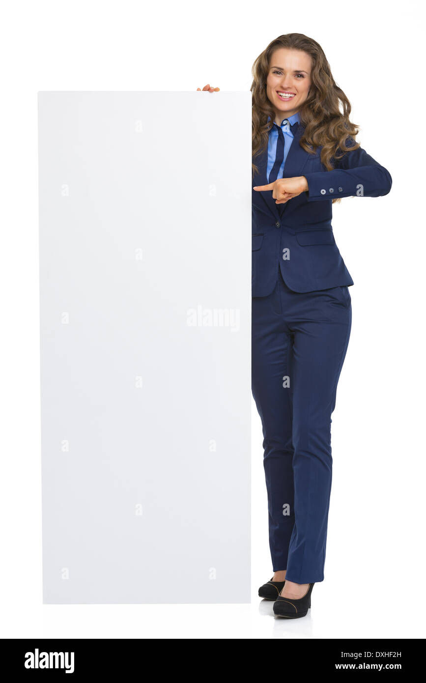 Full length portrait of smiling business woman showing blank billboard ...