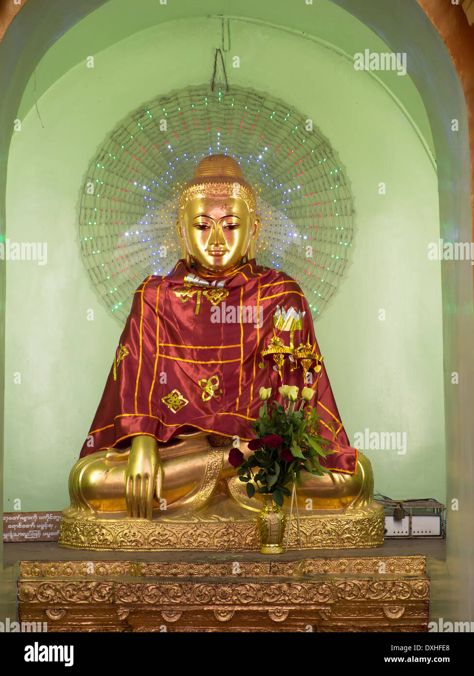 Buddha image with a purple robe and an LED halo around its head, during ...