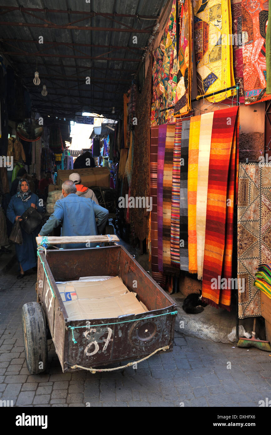 Handcart going down narrow passageway in souk of Jemaa el-Fna square ...