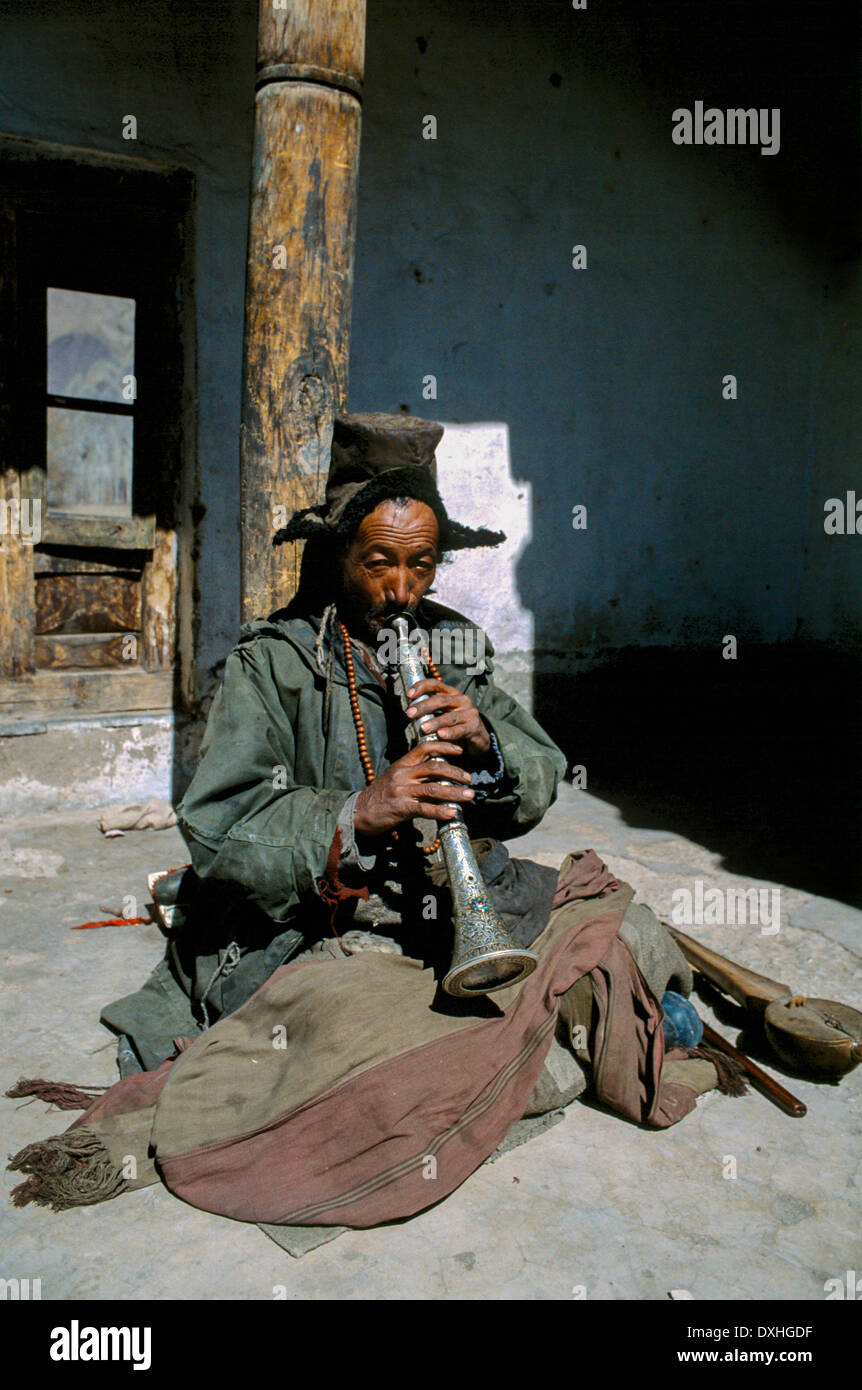Local musician wearing the traditional goncha sat in open courtyard ...