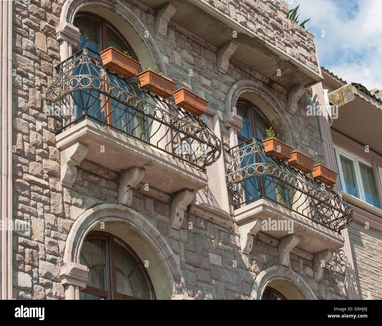 Exterior of an old stone building in city center with balcony and ...