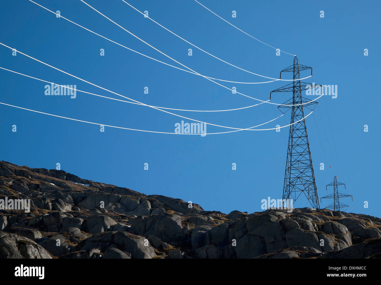 High voltage electric power line in the Swiss alps in front of the lake ...