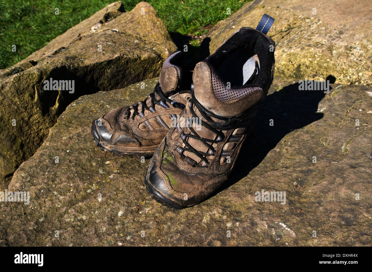 Old, muddy walking boots on rocks Stock Photo - Alamy
