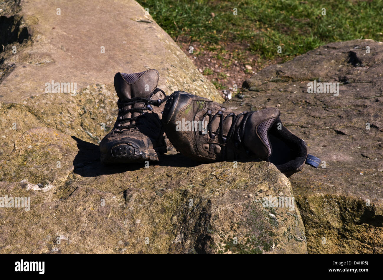 Old, muddy walking boots on rocks Stock Photo - Alamy