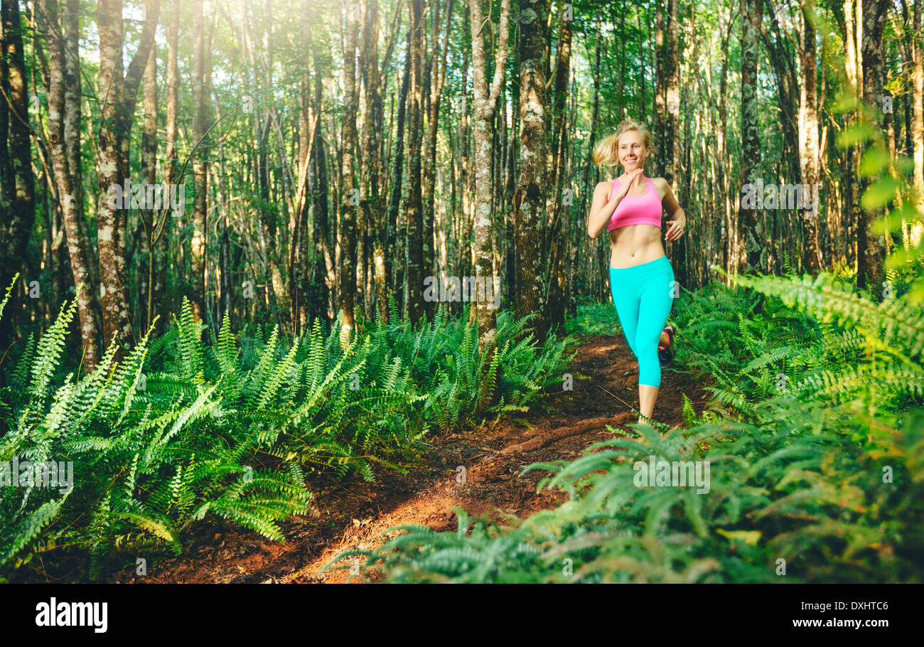Fitness woman running forest trail hi-res stock photography and images ...