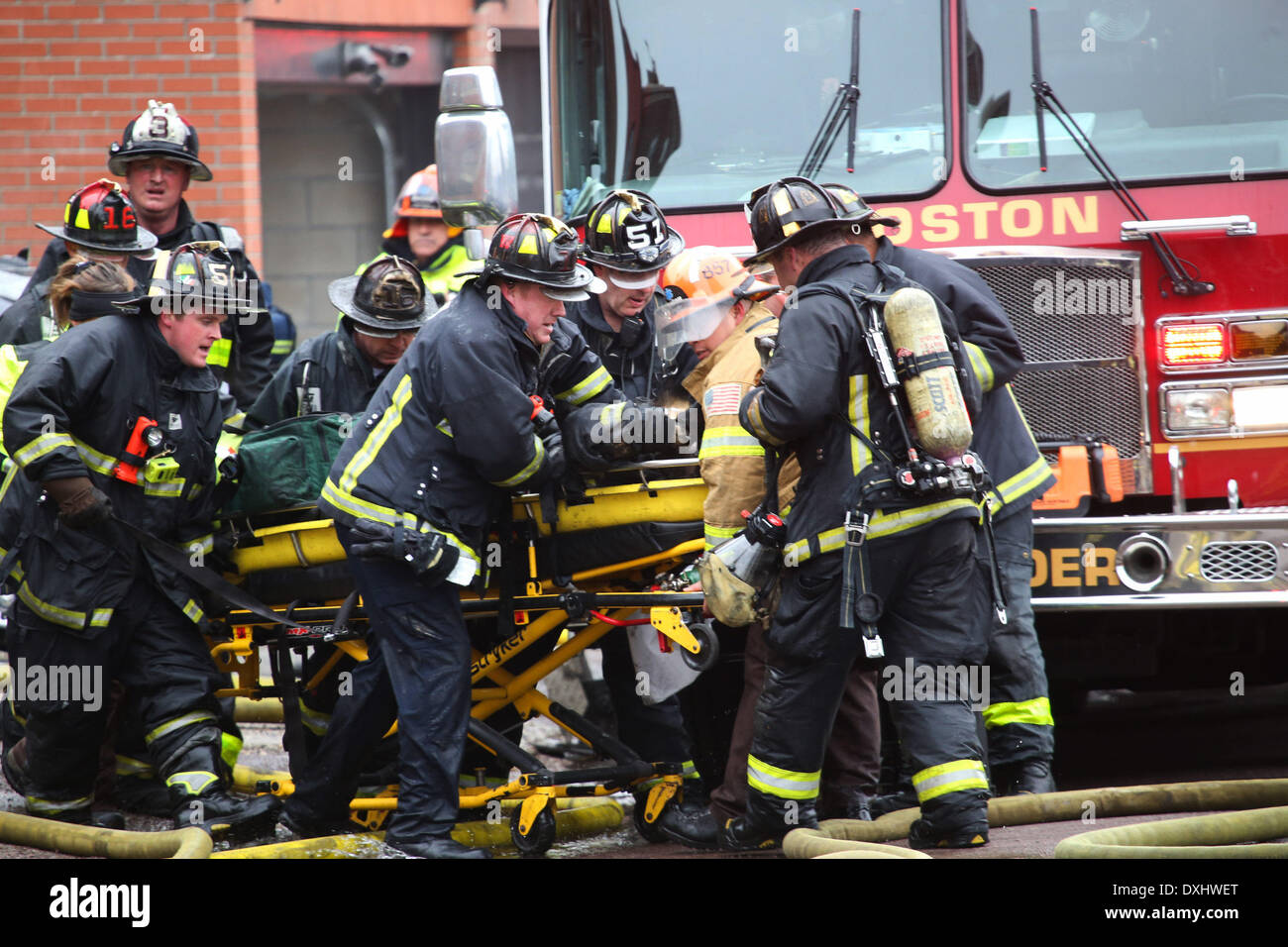 Boston, Massachusetts, USA. 26th Mar, 2014. Fire crews work on a fellow ...