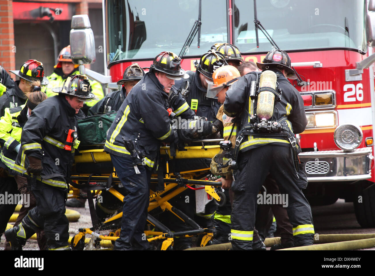 Boston, Massachusetts, USA. 26th Mar, 2014. Fire crews work on a fellow ...