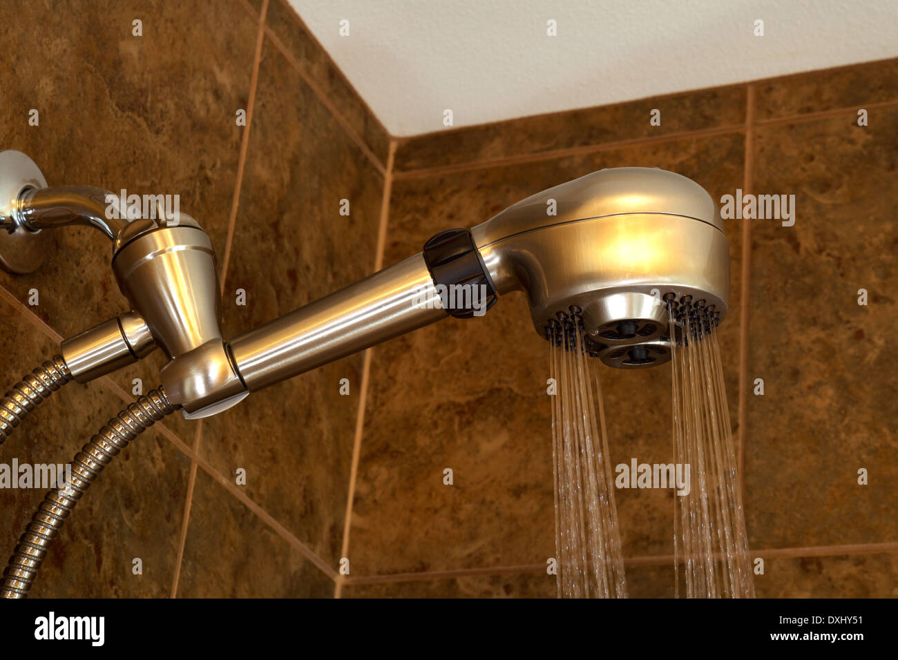 Horizontal photo of running shower head in master bathroom with ceramic ...