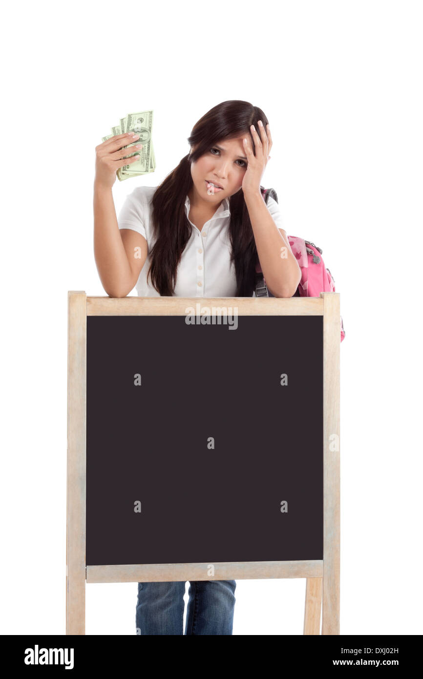 Ethnic Hispanic college student holds 100 dollar bills frustrated by ...