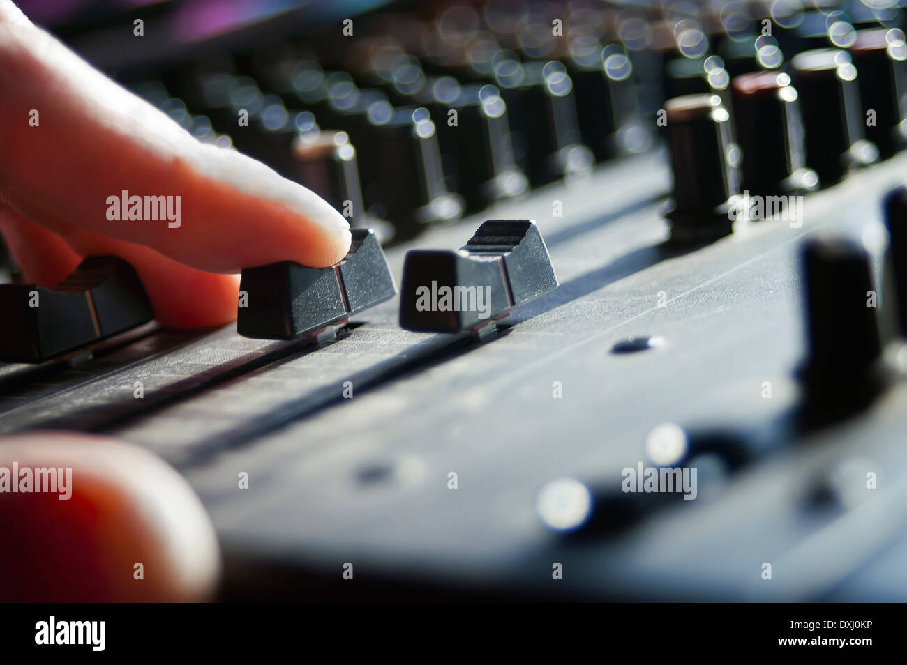 DJ hand over an audio mixing console Stock Photo - Alamy